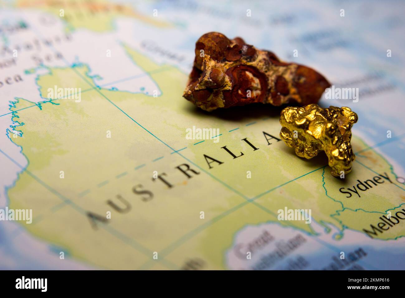 Close-up of Bauxite mineral or aluminium ore and gold nugget on top of ...