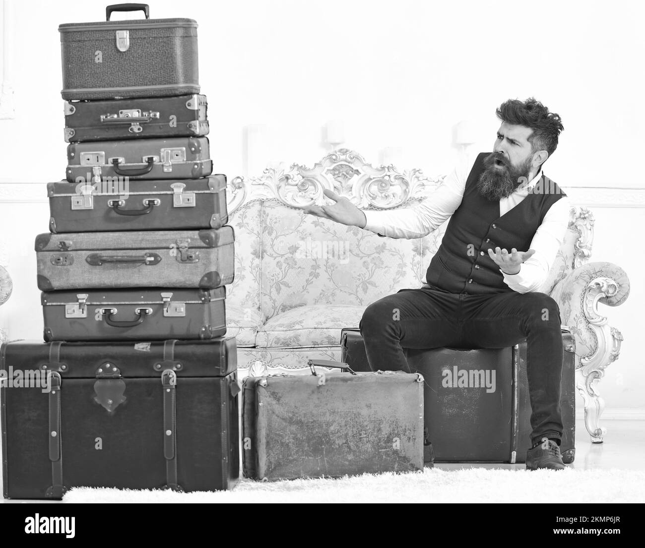 Macho elegant on surprised face sits shocked near pile of vintage ...