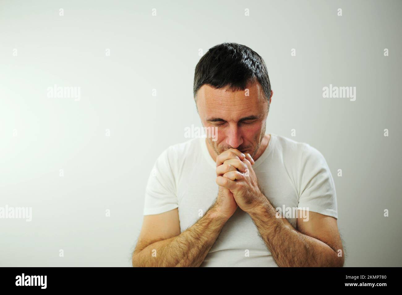 Adult man upset he put his hands on his face Prayer experience crying ...