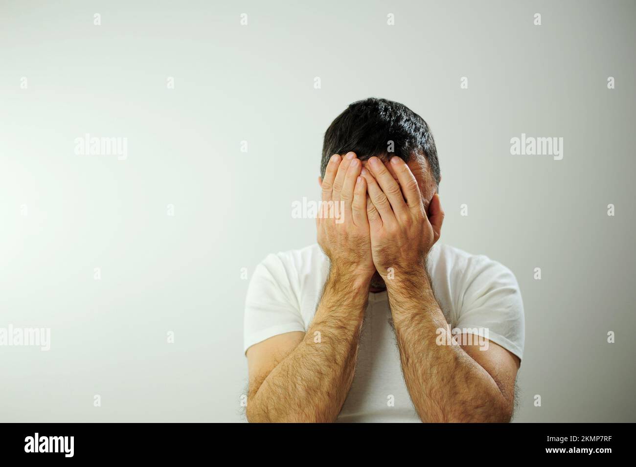 Adult man upset he put his hands on his face Prayer experience crying ...