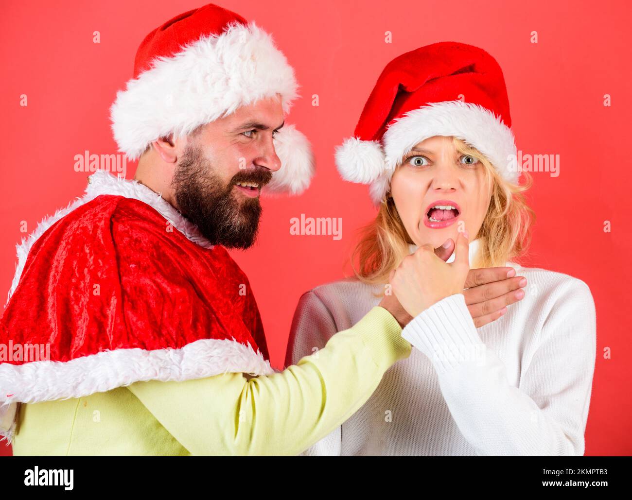 Girl choking while man hold her neck celebrate christmas. Man with ...