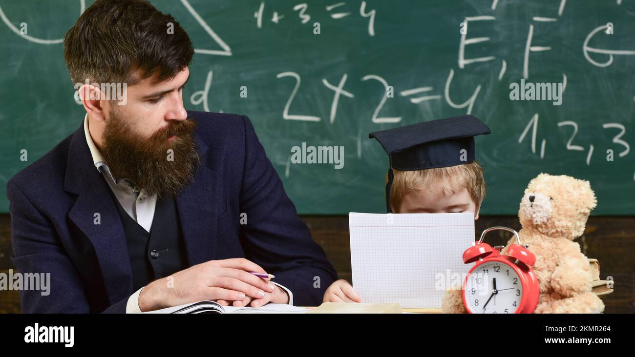 Elementary education concept. Kid studies with teacher, listening with ...