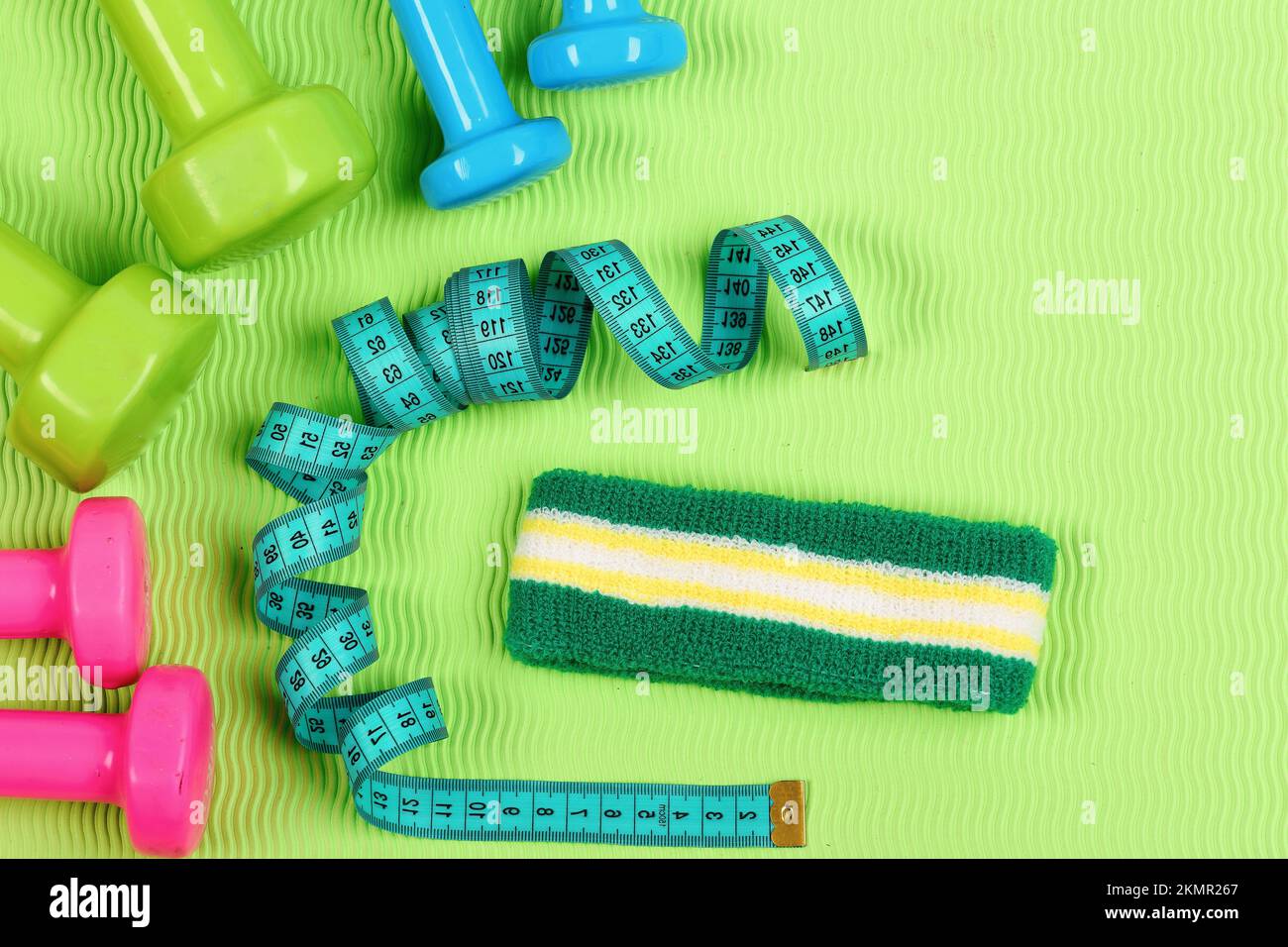 Shaping and fitness equipment. Barbells next to twisted tape measure ...