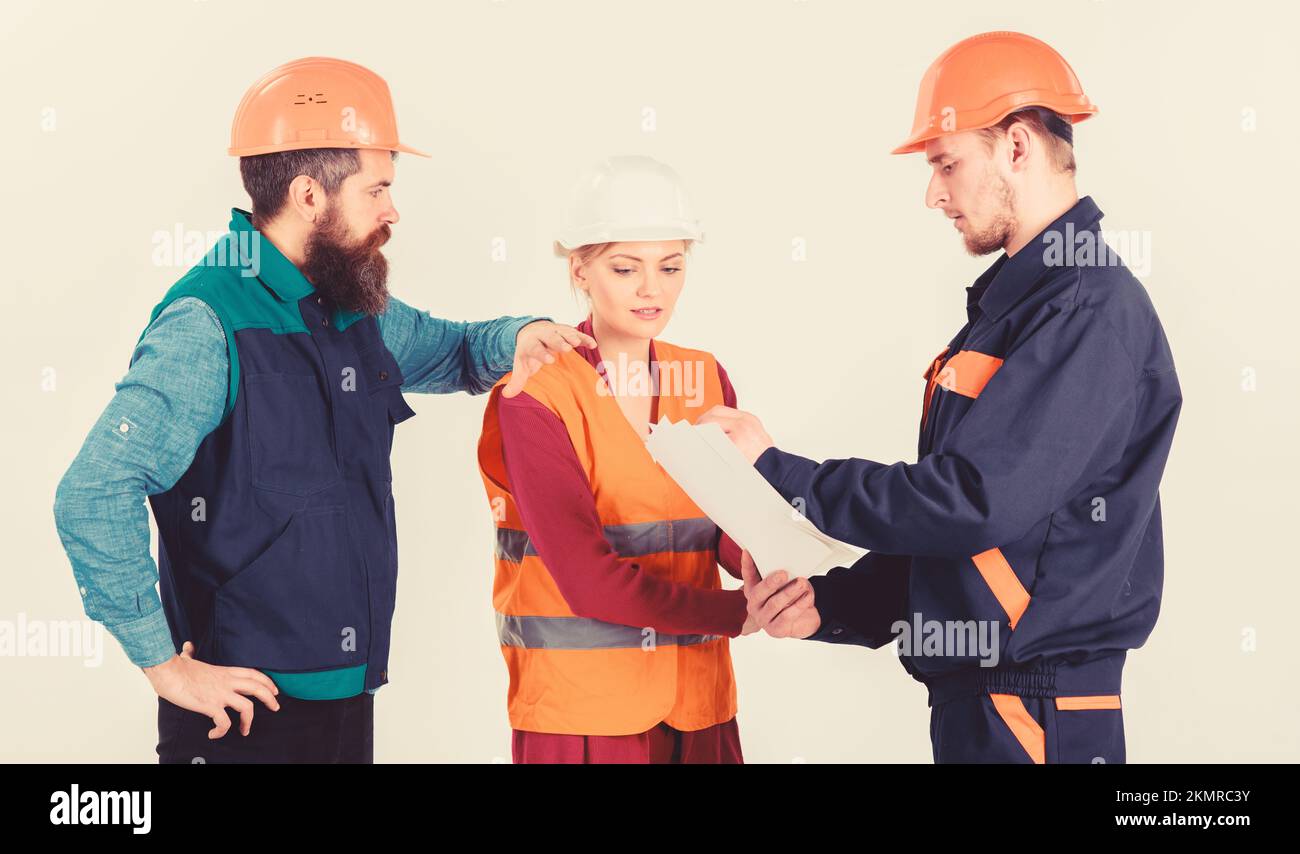 Men in hard hats, uniform and woman. Teamwork problems Stock Photo - Alamy