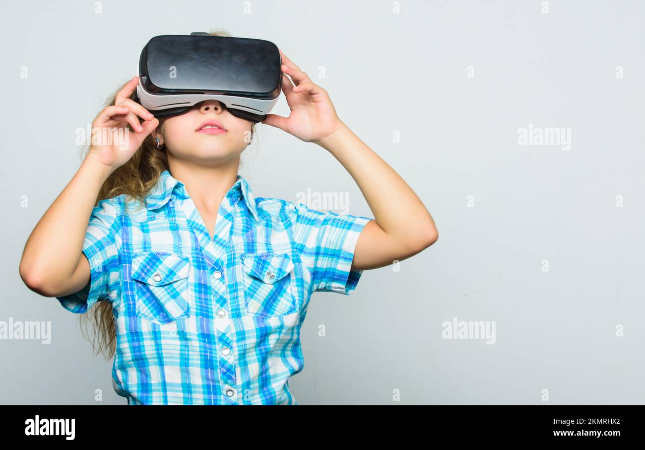 Little child in VR headset. Small child wear wireless VR glasses ...