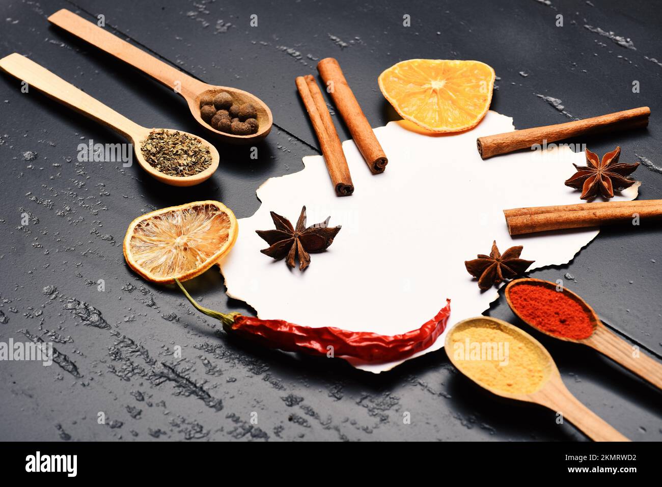 Set of dry spices on grey background. Condiment on paper Stock Photo ...