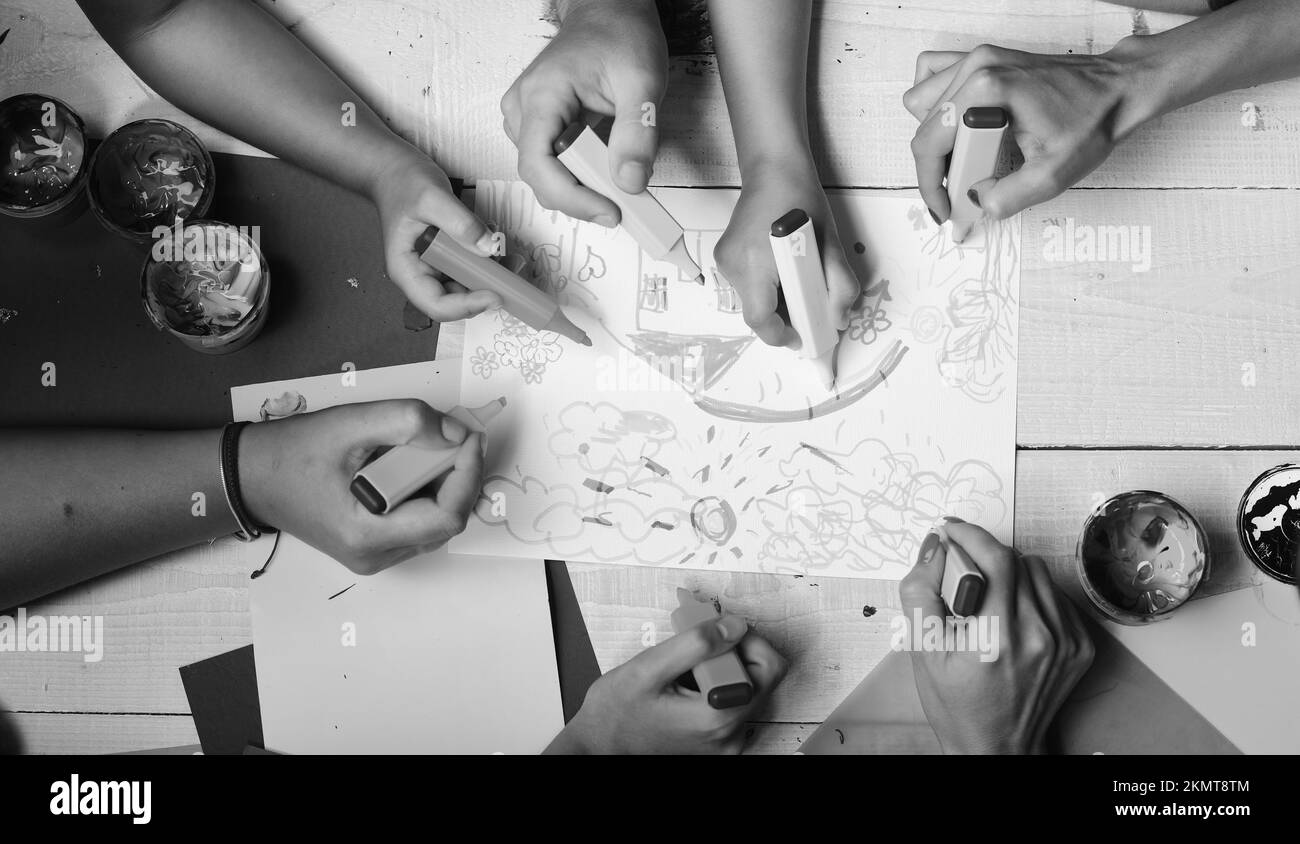 Hands hold colorful markers and draw kids illustration, top view Stock ...