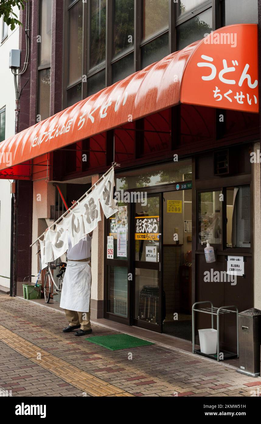 Bringing in the noren curtain at Chikusei Udon after the lunch rush ...
