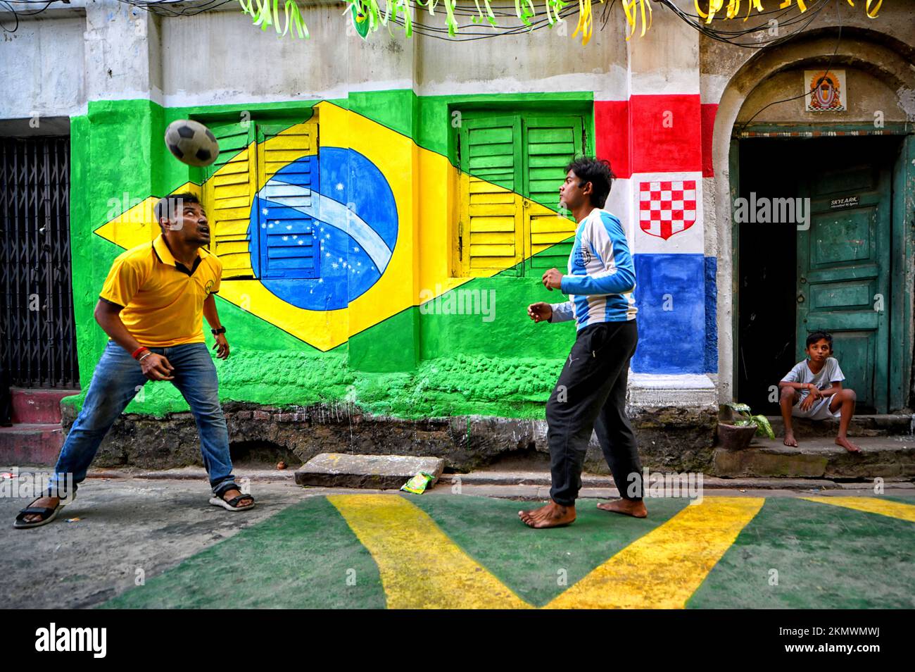 Members of Dishari club seen playing football in front of street art ...