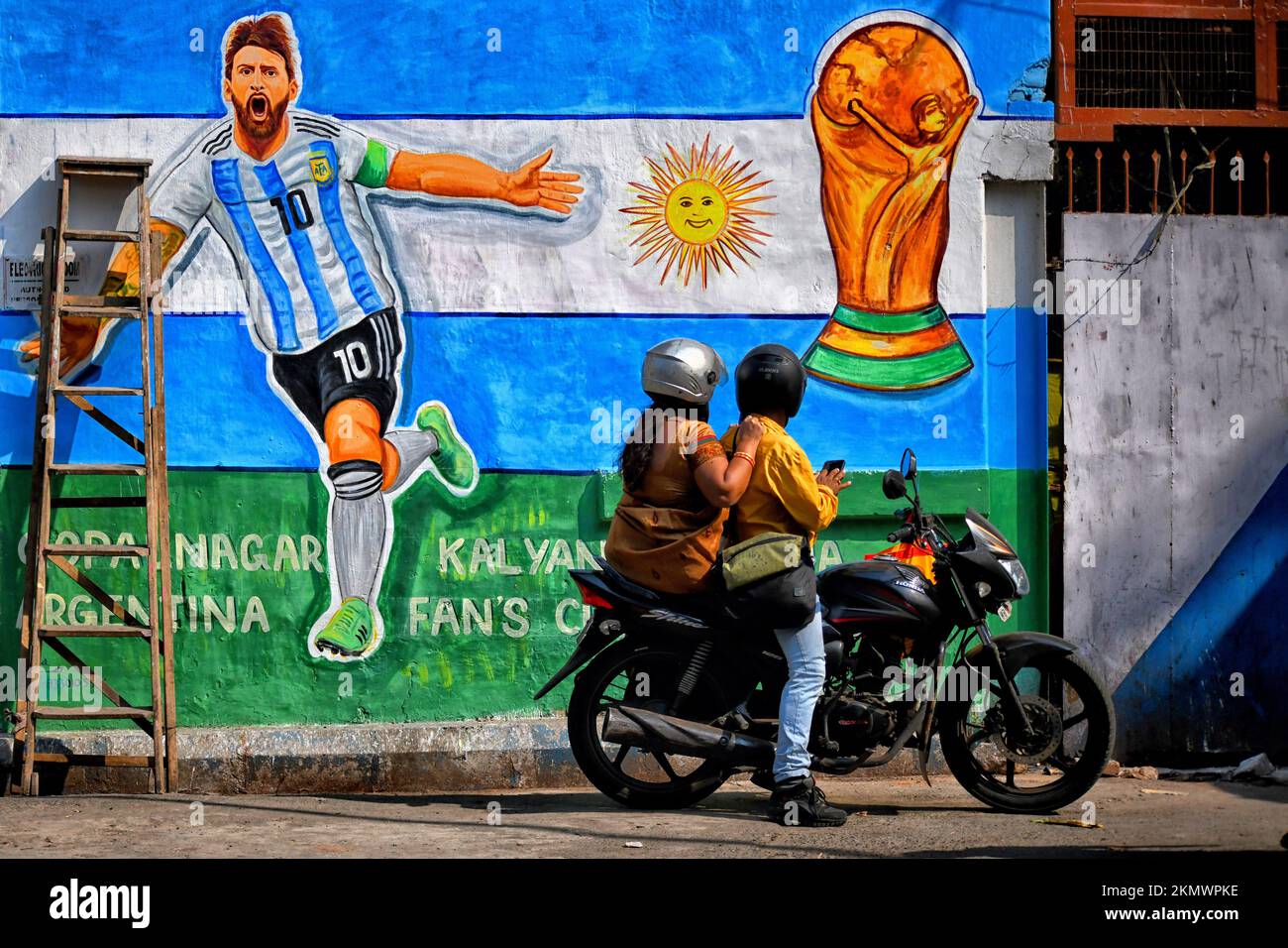 People take photos of a wall graffiti of Argentina football player ...
