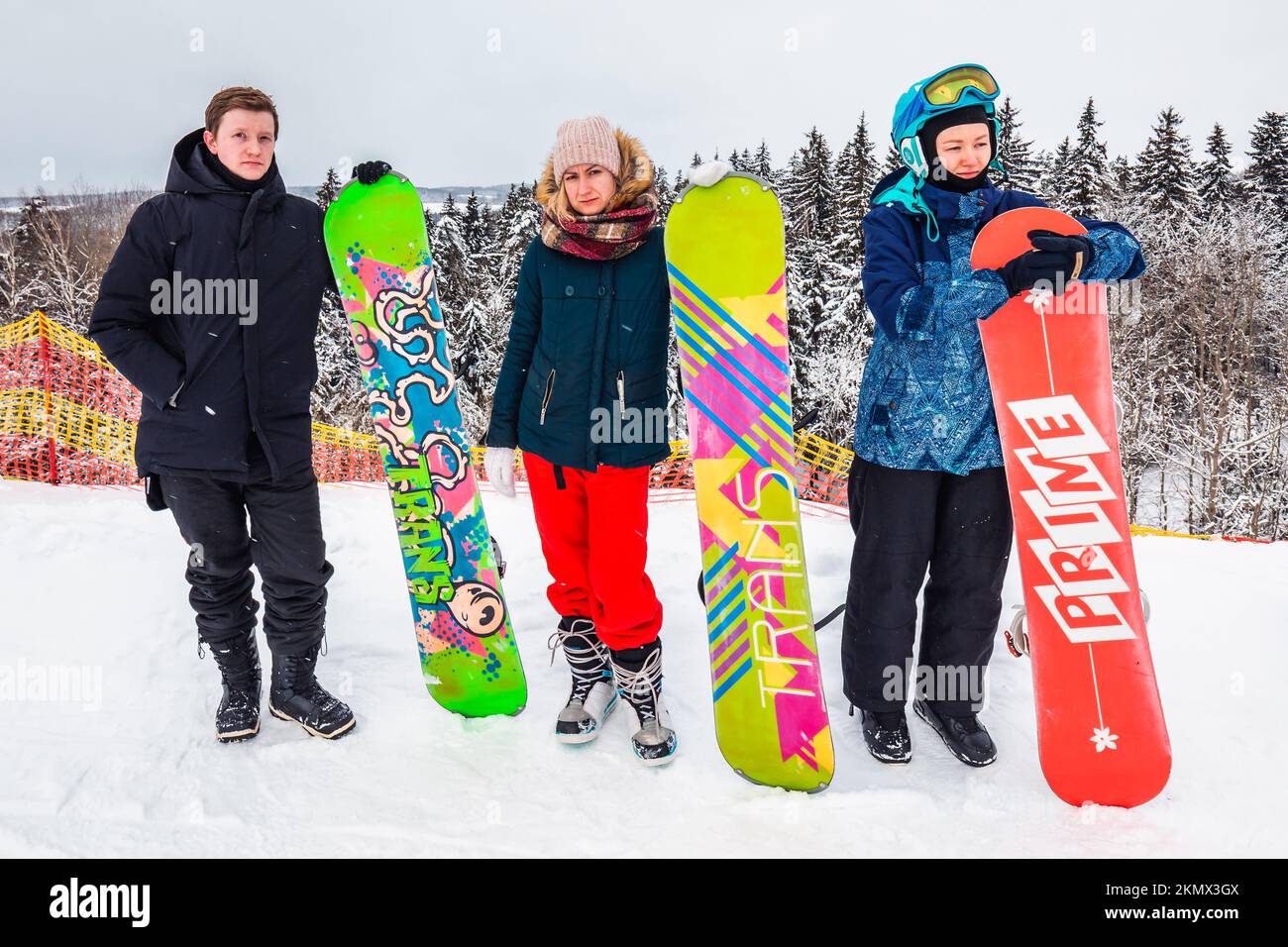 Friends riding on a snowboard in the winter Stock Photo - Alamy