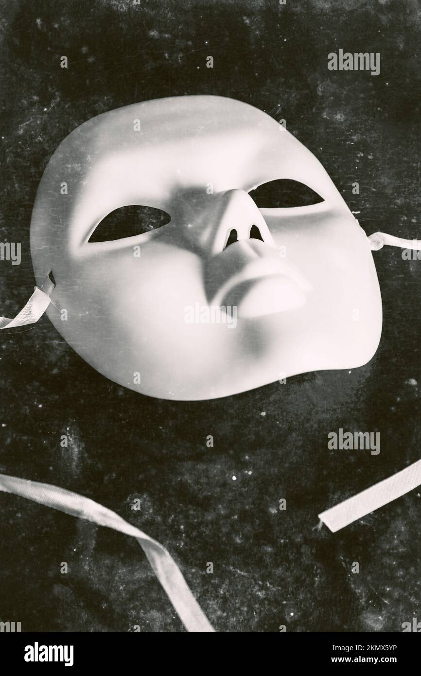 Vintage performing arts still life on a textured mime mask with faded ...