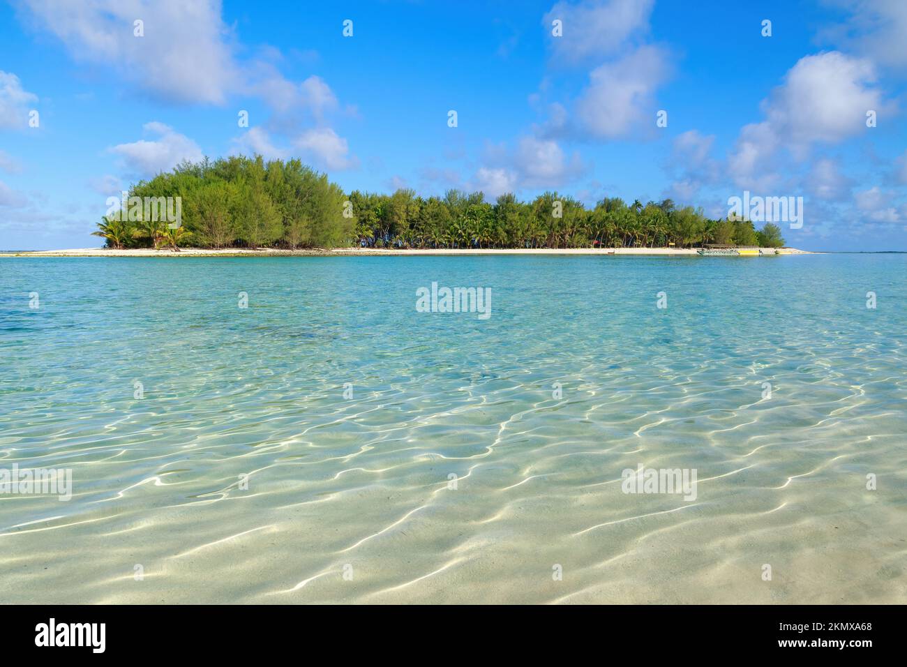 A small tropical island in the middle of a turquoise lagoon (Koromiri ...