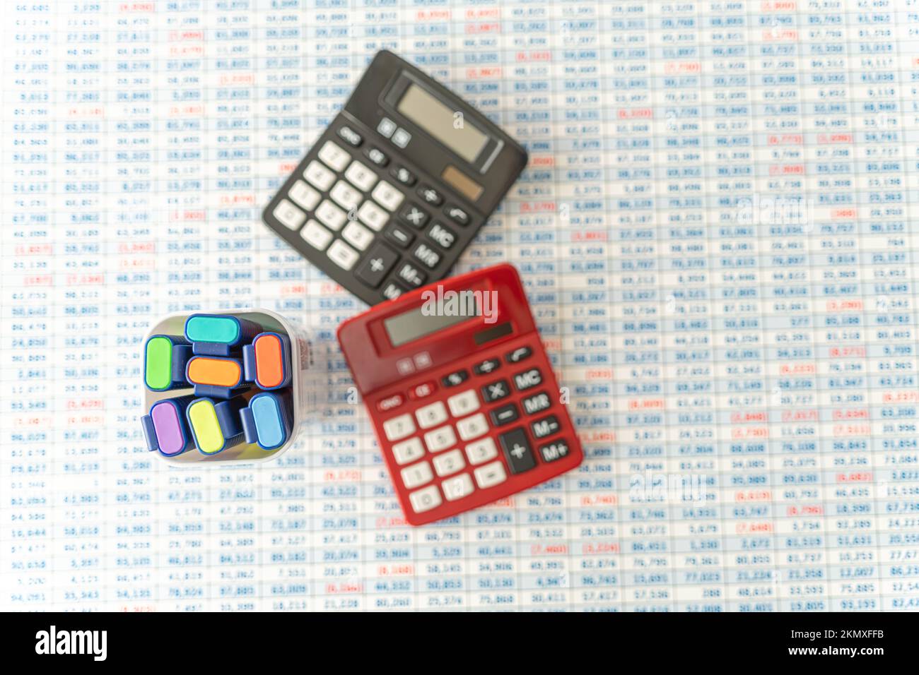 Highligters with Calculators on top of Spreadsheet background Stock ...