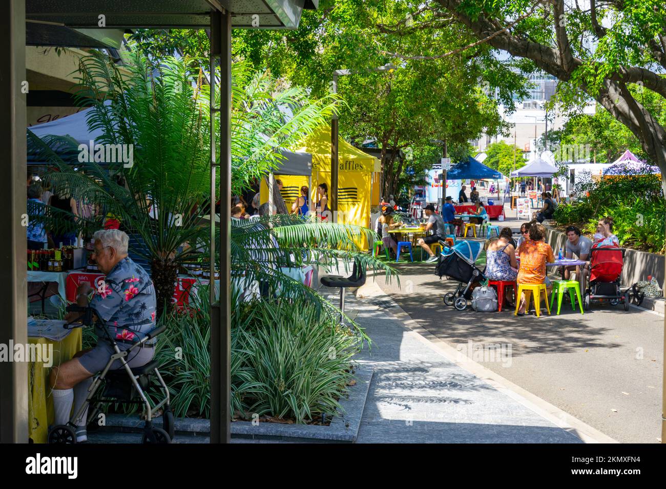People sitting on sidewalk outside cafes in shade of trees, Flinders ...