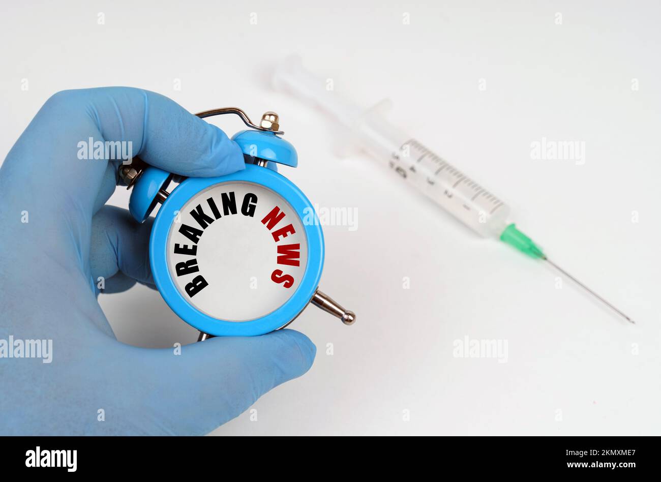 Medicine concept. There is a syringe on the table, an alarm clock in ...