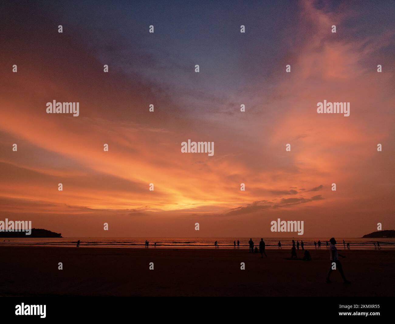Silhouette of people enjoying the sunset on the Miramar Beach state Goa ...