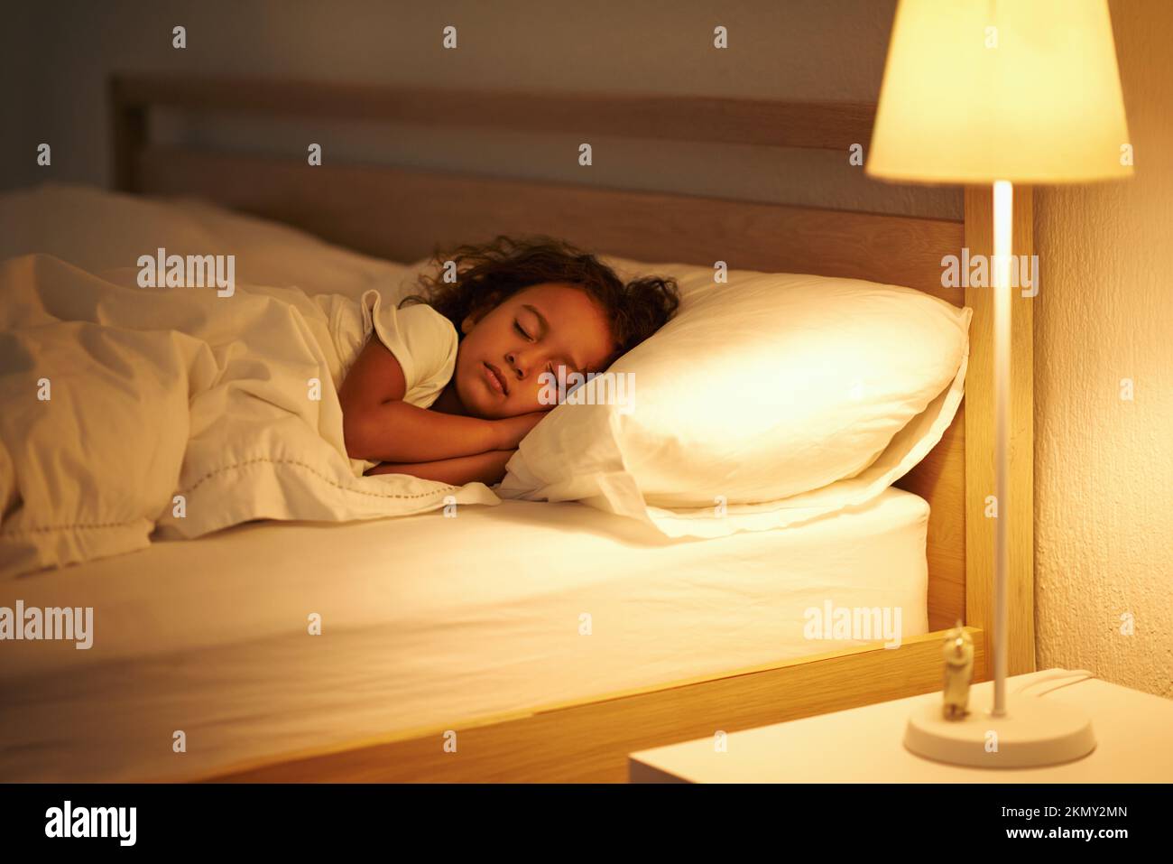 I like moms bed the best. A cute little girl fast asleep in a double ...