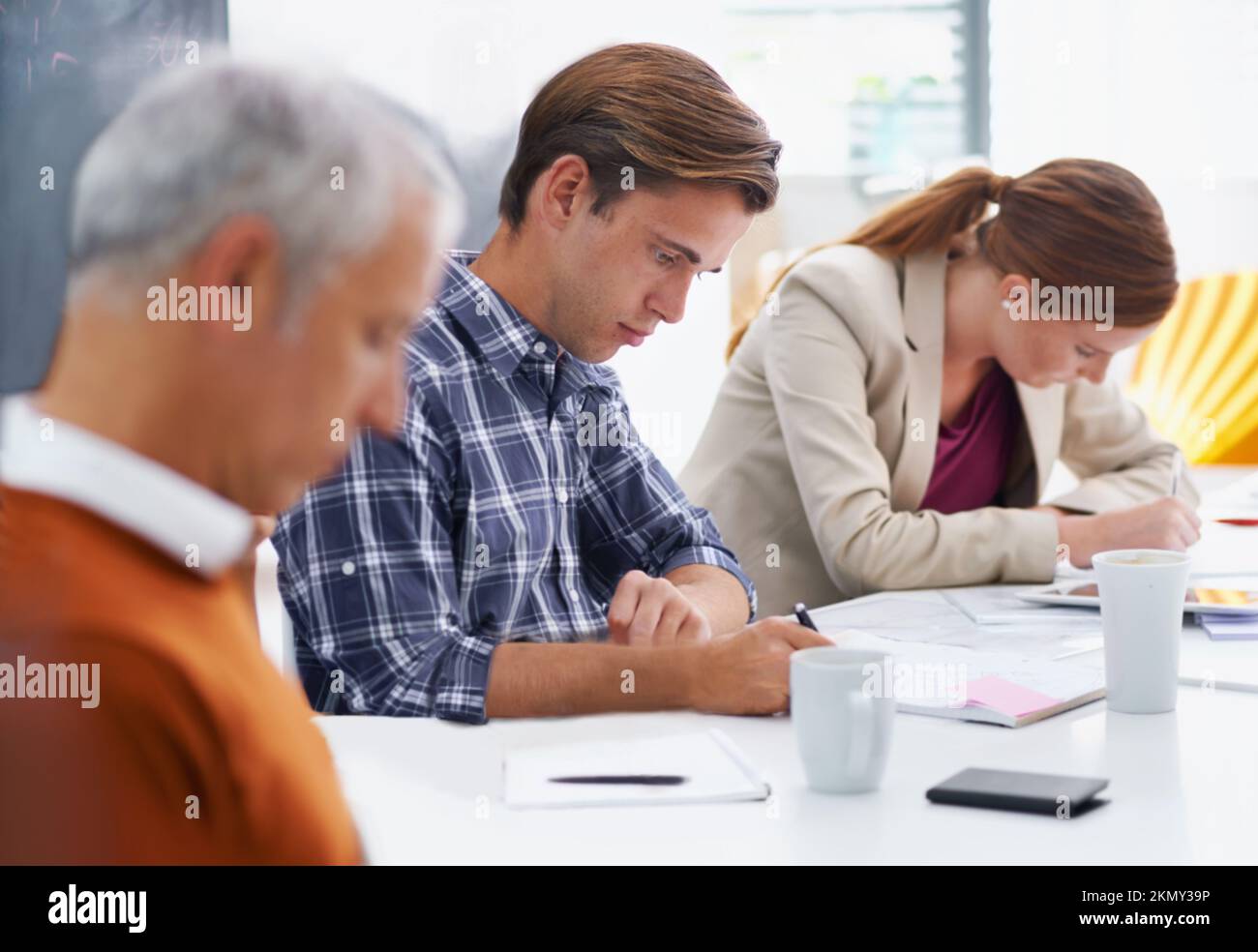 Three heads get the job done. A group of colleagues working in an ...