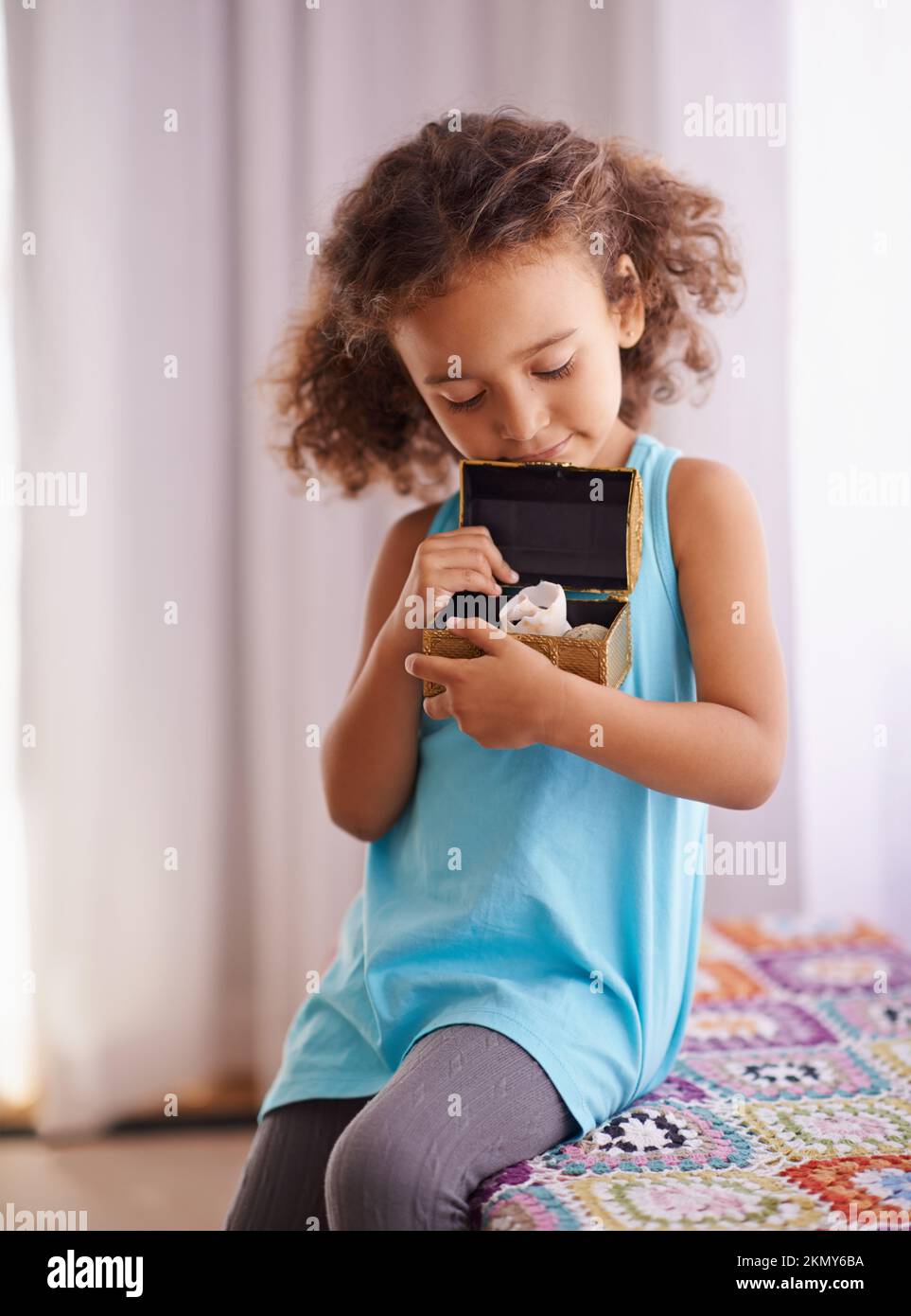 My box of treasures. an adorable little girl holding a box Stock Photo ...