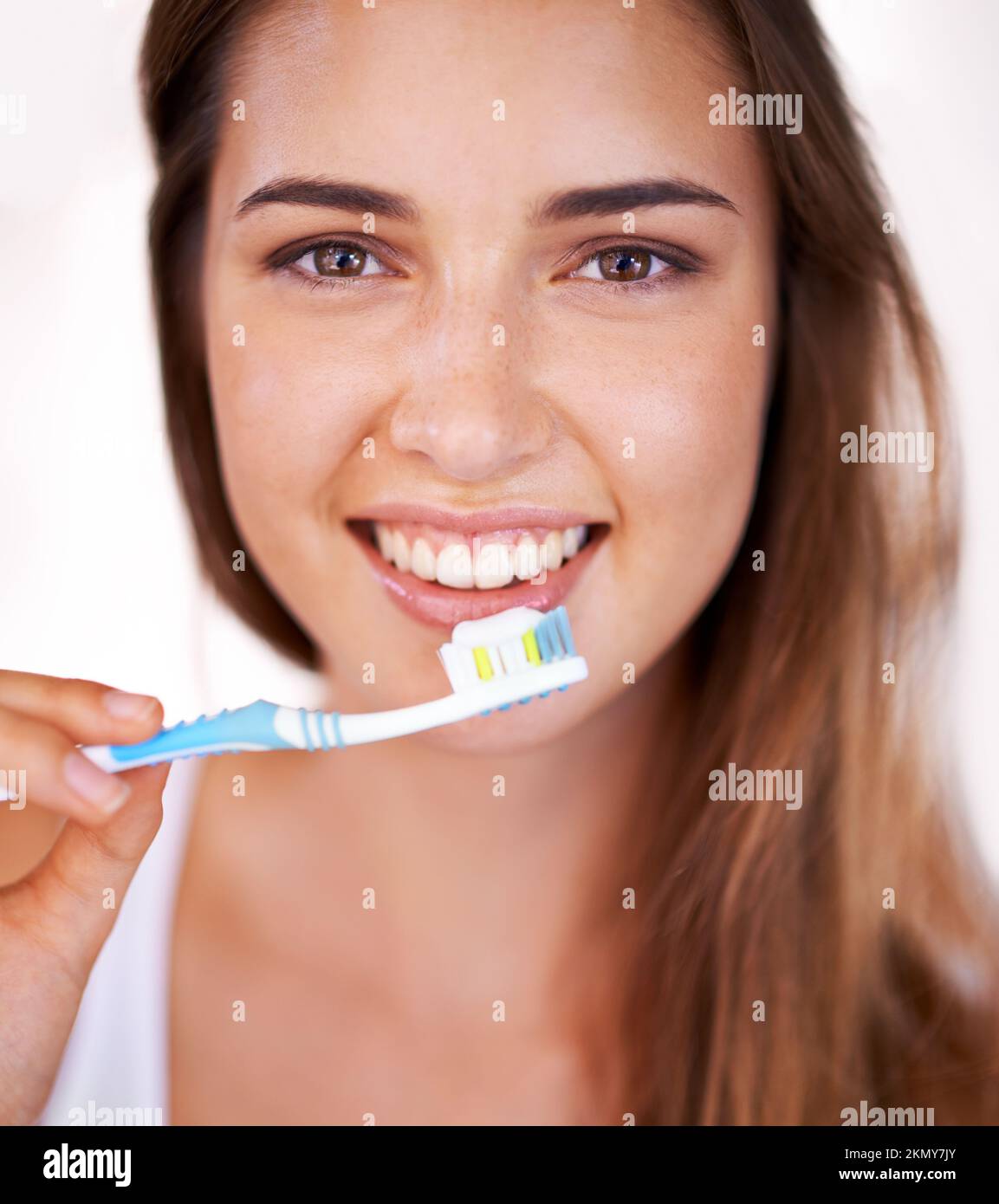 I want my smile to be stunning. a young, pretty girl brushing her teeth ...