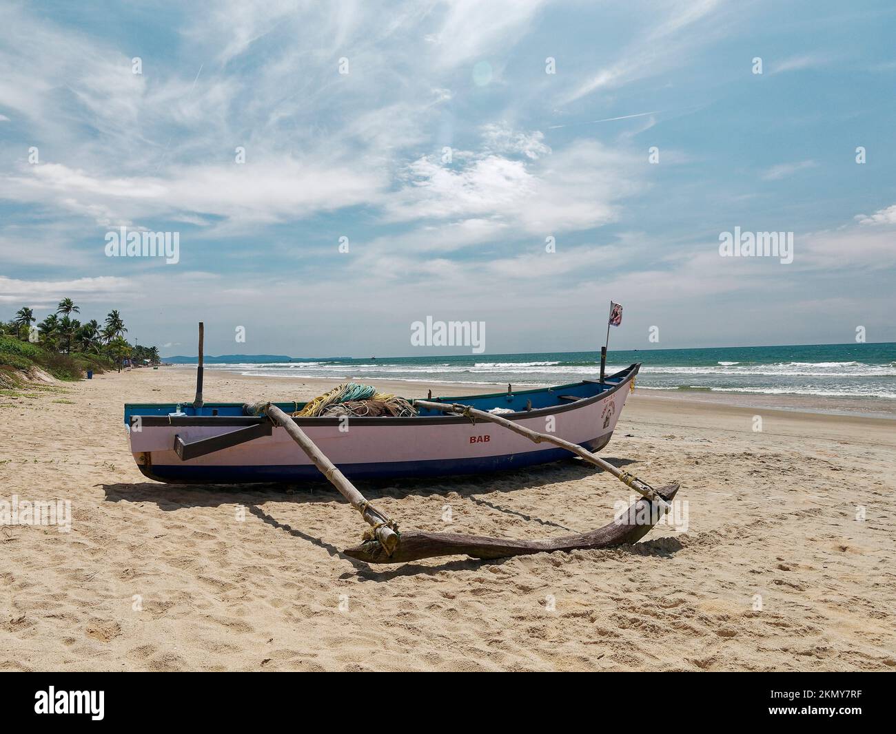 Beautiful beach with traditional fishing boat and blue sky in Colva ...