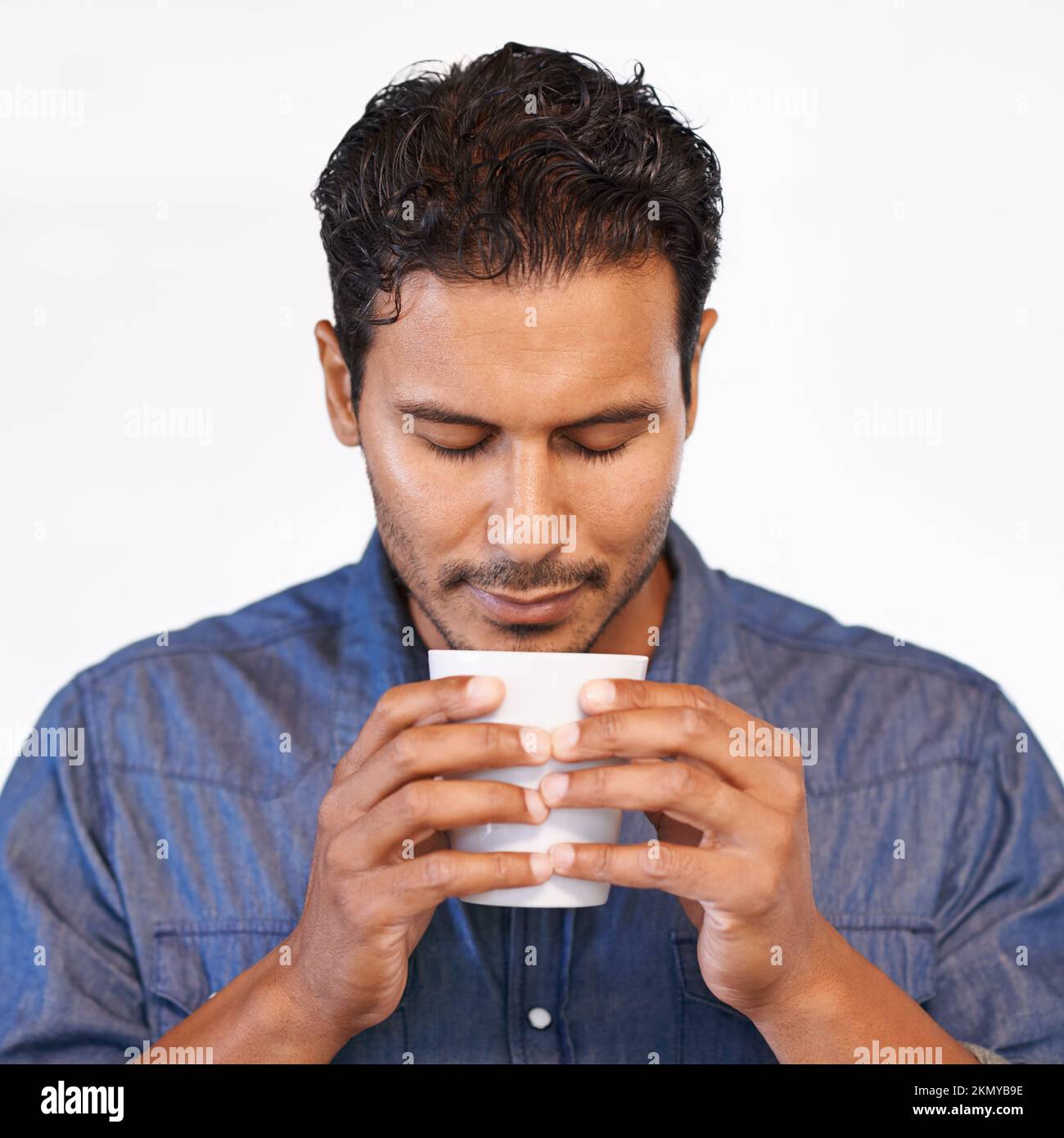 My first cup of the day. A handsome man drinking a cup of coffee ...