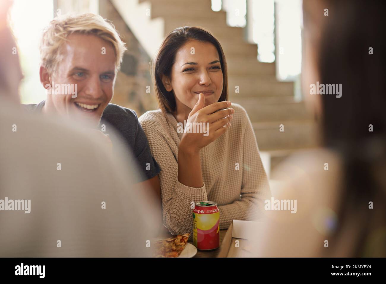 So yummy. a group of friends enjoying pizza together Stock Photo - Alamy