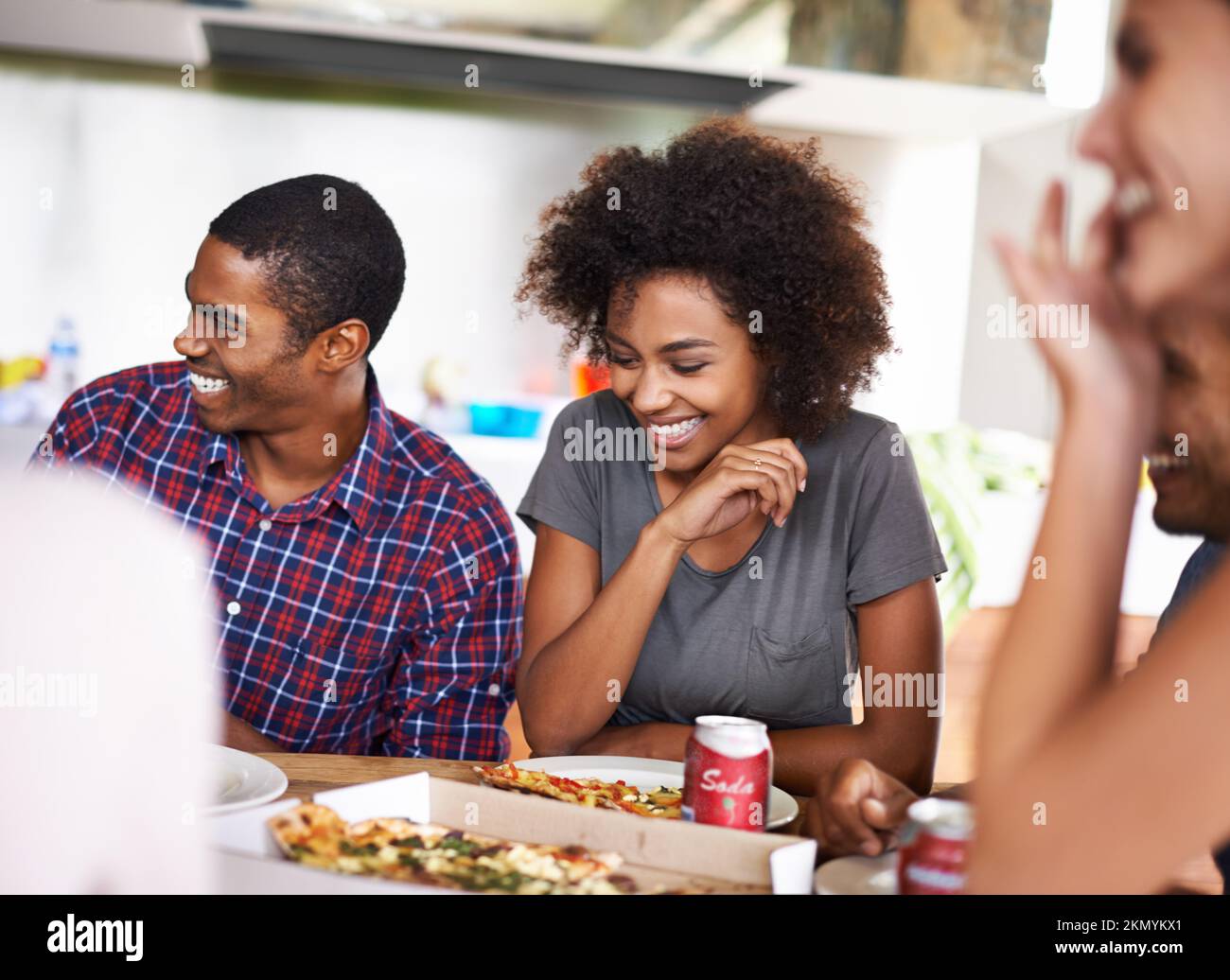 Celebrating the weekend with a pizza get-together. a group of friends ...