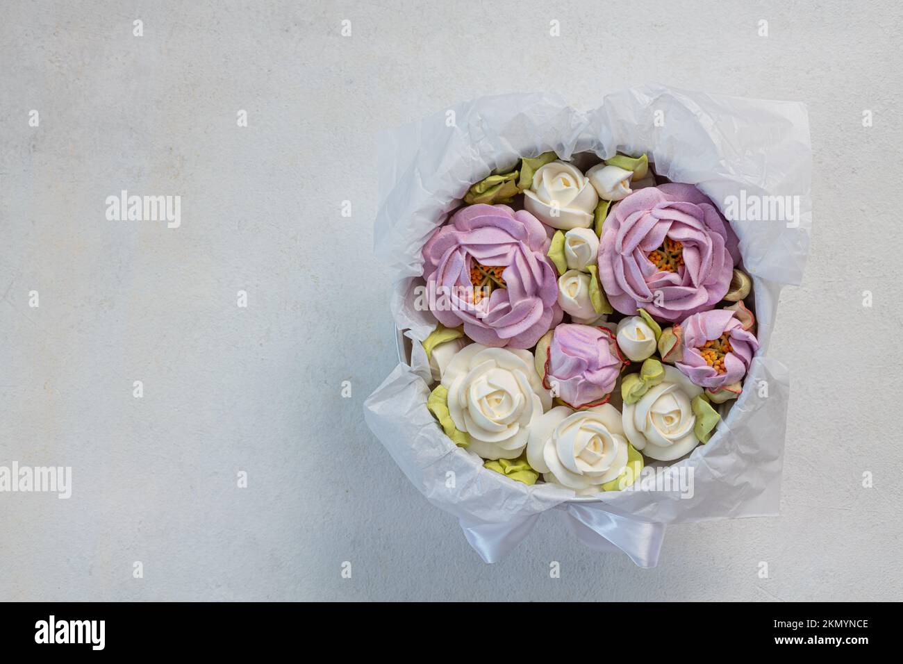 Zephyr bouquet of flowers in a gift box on a light background, top view ...