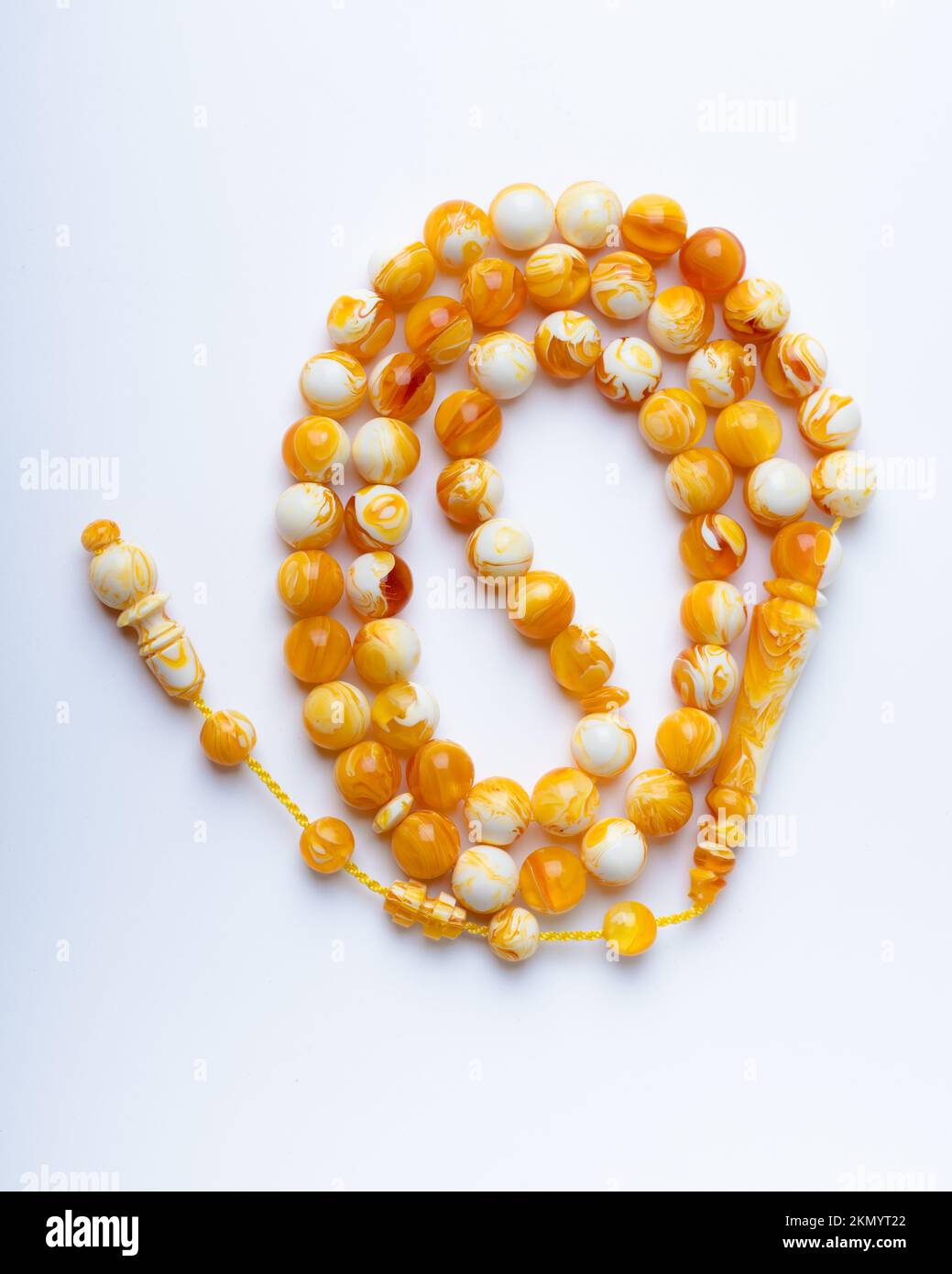 A top view of a colorful Islamic gemstone rosary isolated on white ...