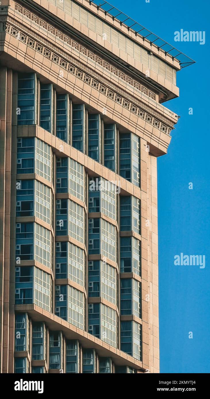 A facade shot of a modern skyscraper with pattern glass windows with ...