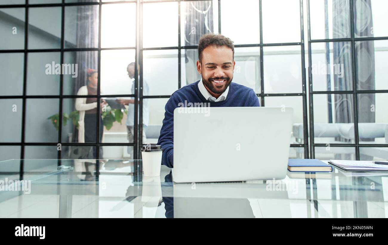 businessman working on a laptop in a modern office Stock Photo - Alamy