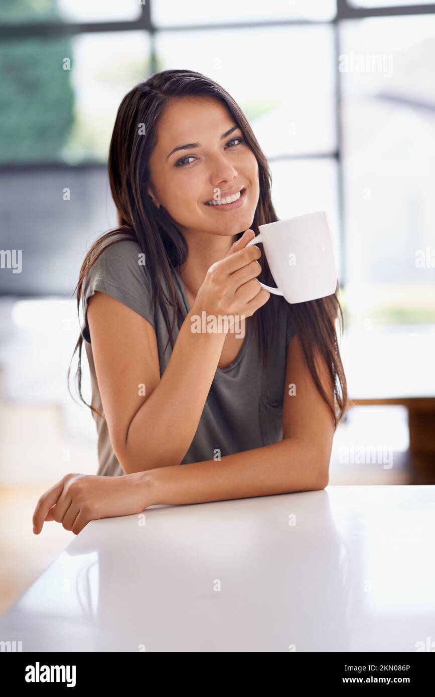 Relaxing with a cup of java. an attractive young woman drinking a ...