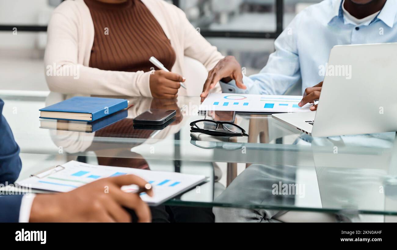 smiling businessman sitting near the office desk Stock Photo - Alamy