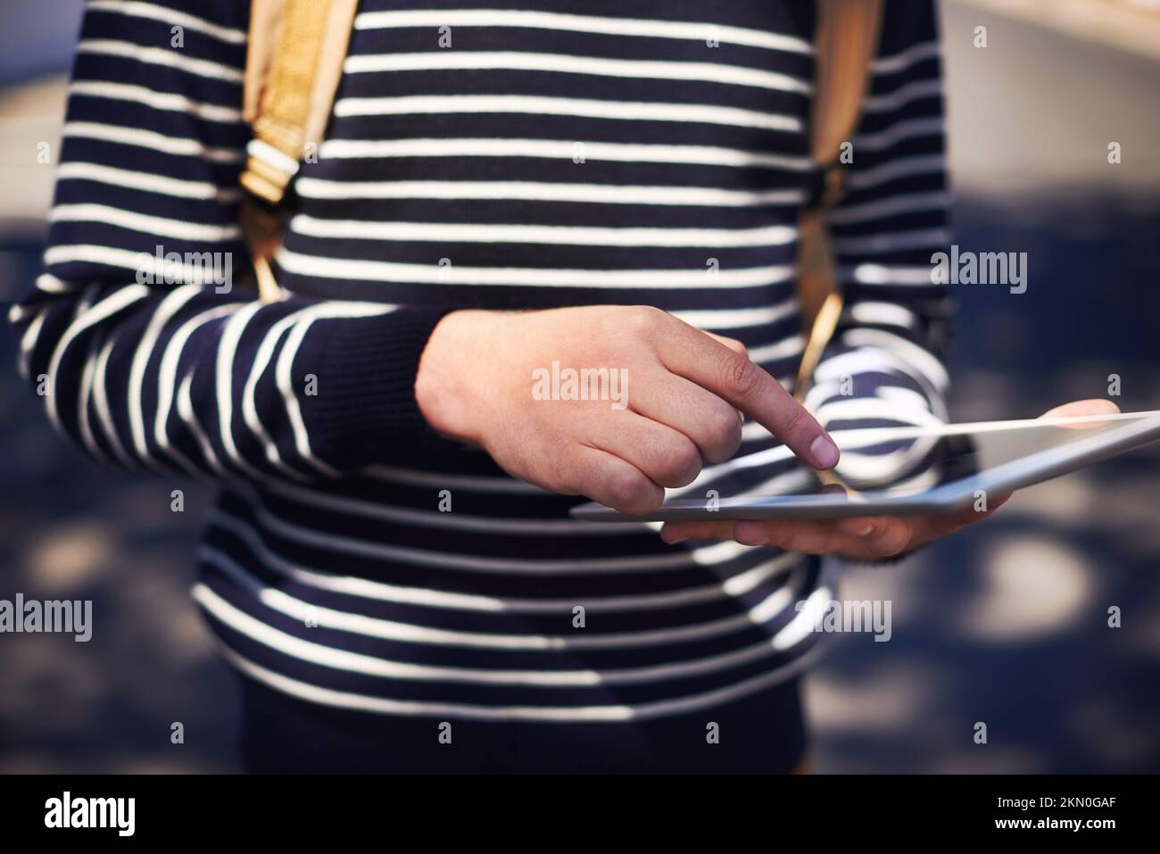 Using touchscreen technology. a hipster using a touchscreen device Stock Photo - Alamy
