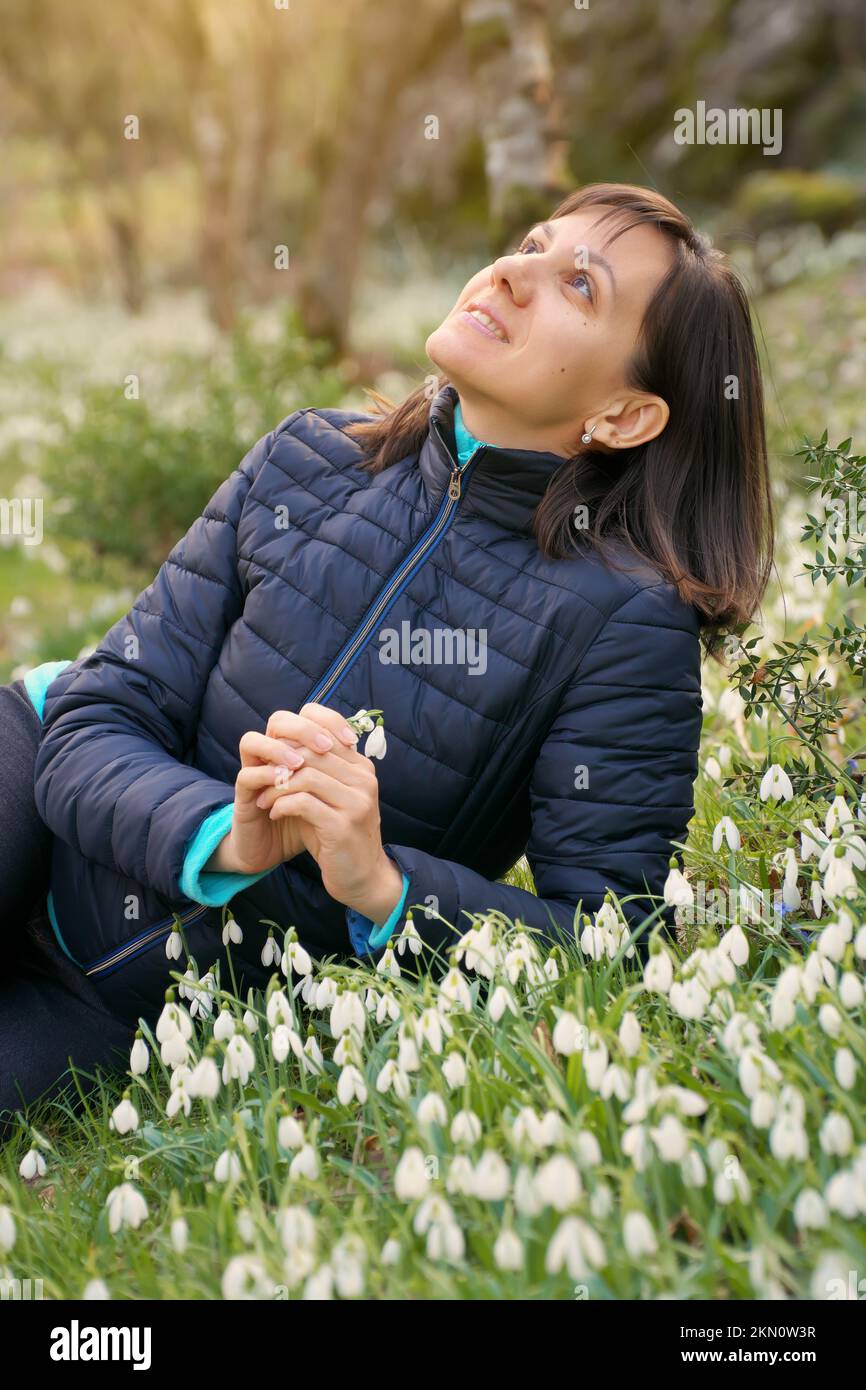 Young woman rest in field of snowdrops. Nature and relax scene Stock ...