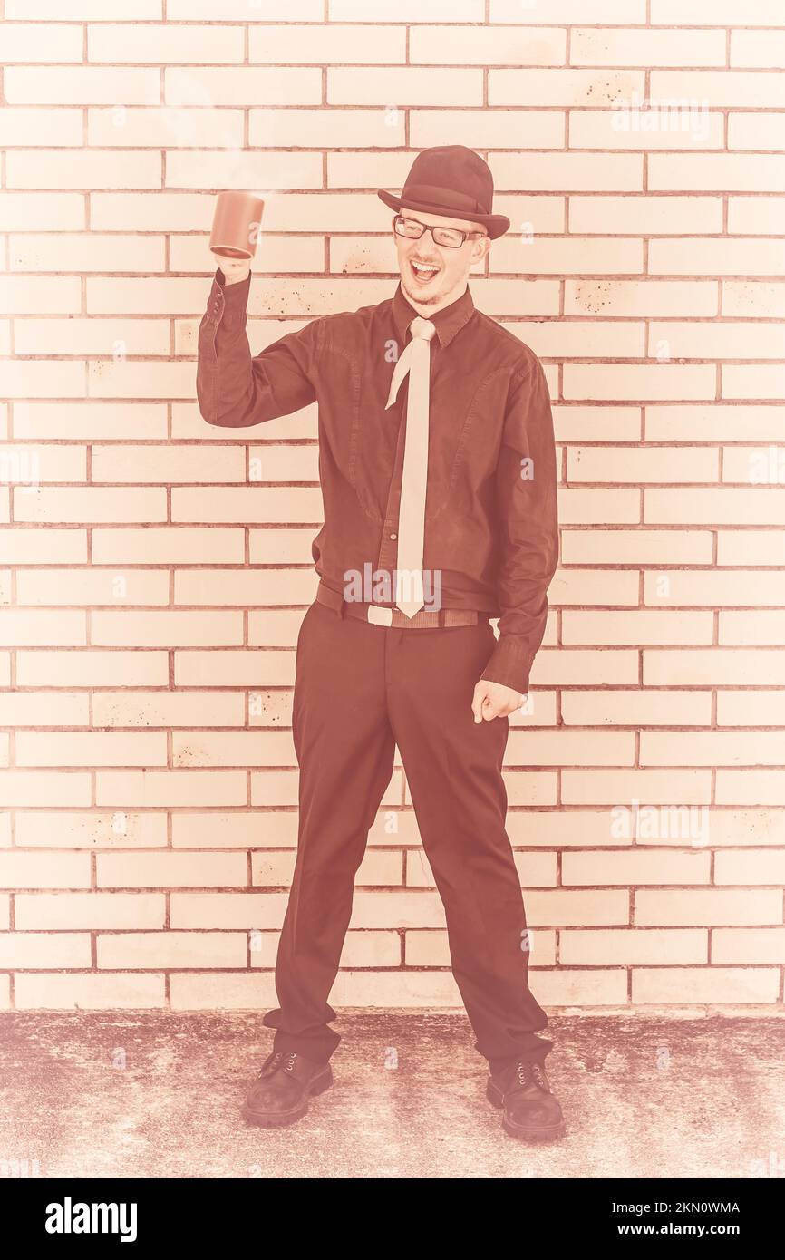 Full length old-fashioned photograph of a coffee drinking guy holding ...
