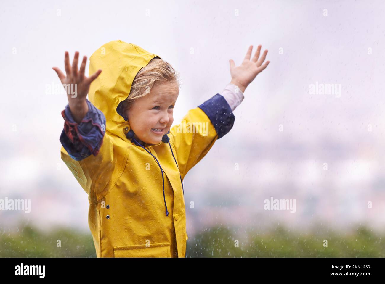 Loving life come rain or shine. an adorable little girl playing outside ...