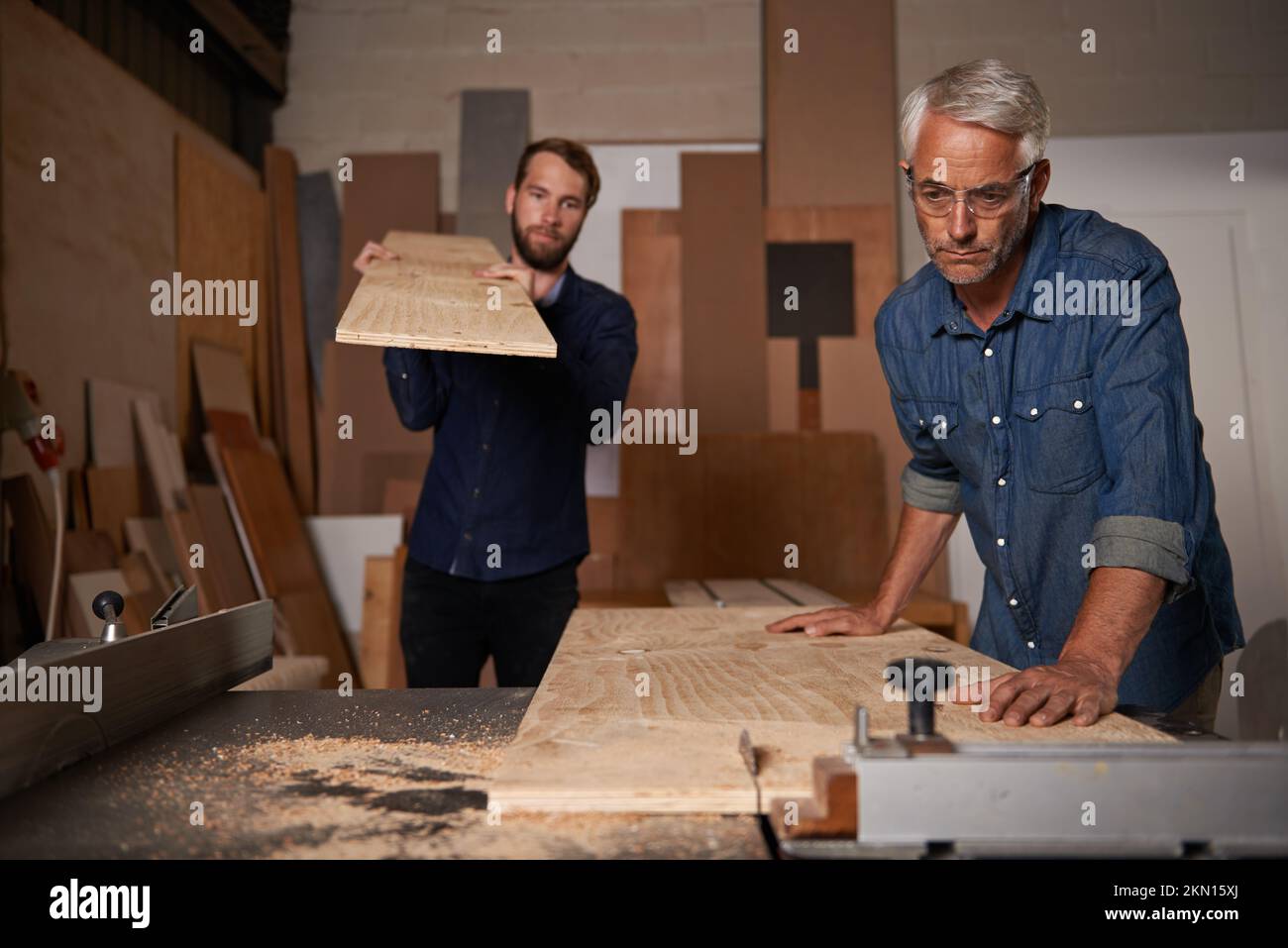 What time is it Wood work time. a father and son working together in a ...
