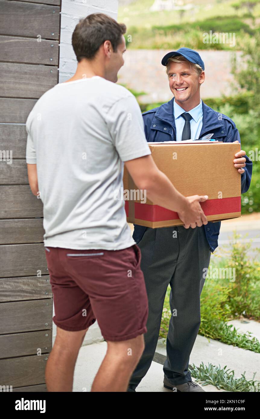 There you go, sir. a young man receiving a cardboard box from a ...