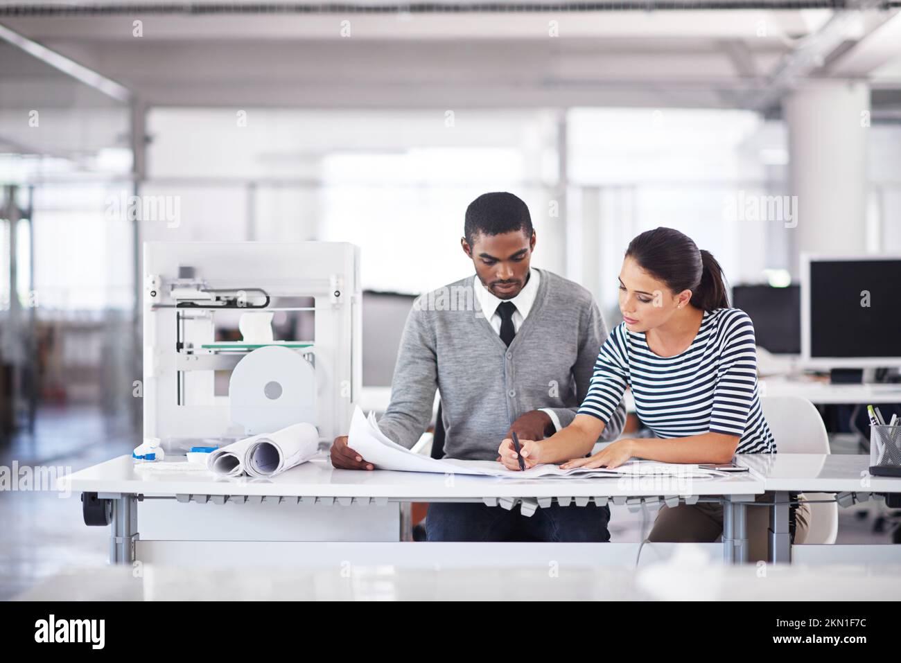 Deciding on the perfect new design. two colleagues talking together ...