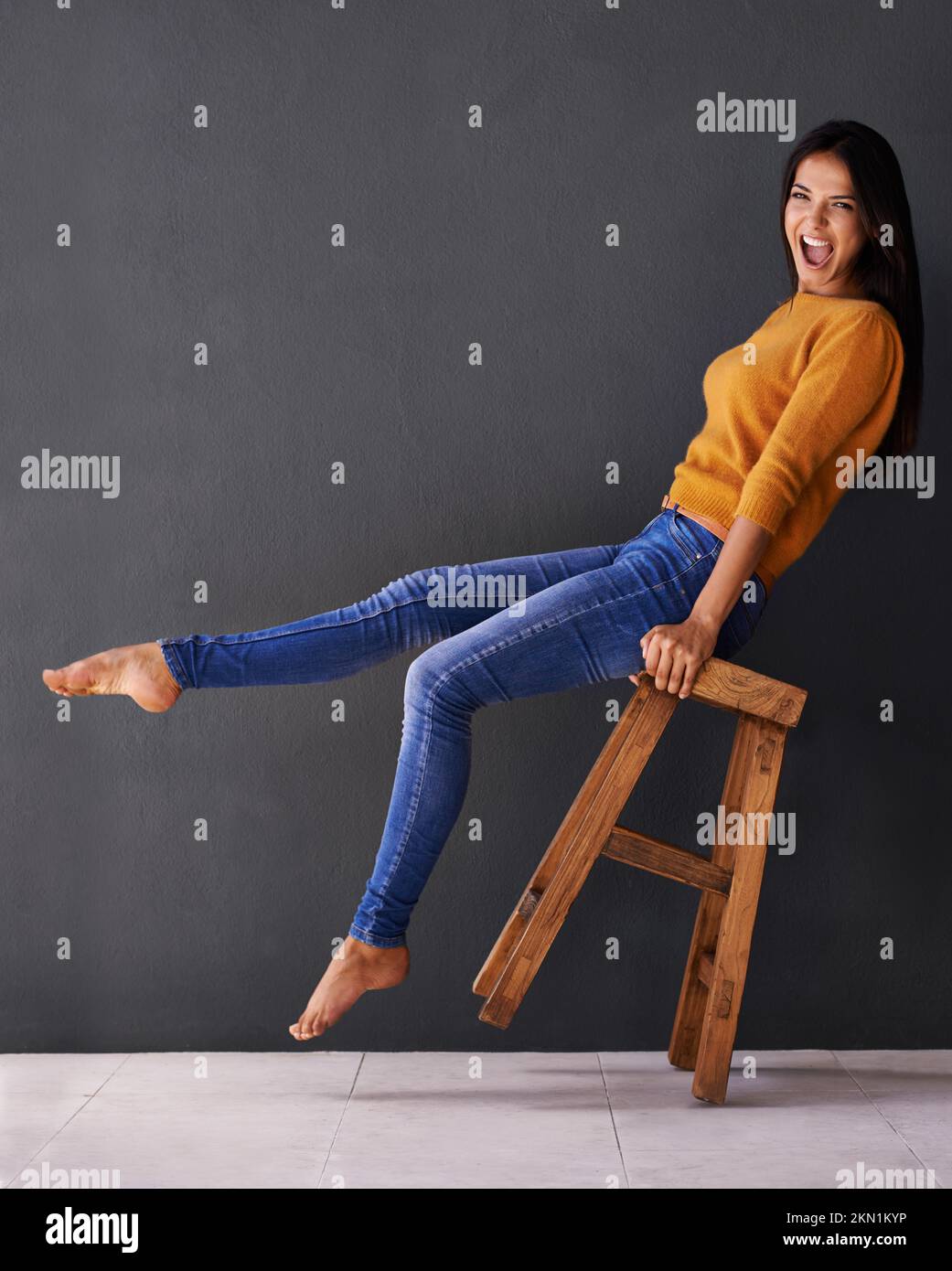 She likes her thrills. Portrait of an excited young woman leaning back ...