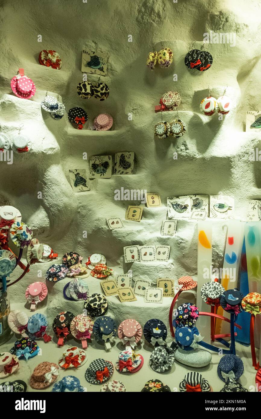 Shop window made of white stone with colorful objects Stock Photo - Alamy