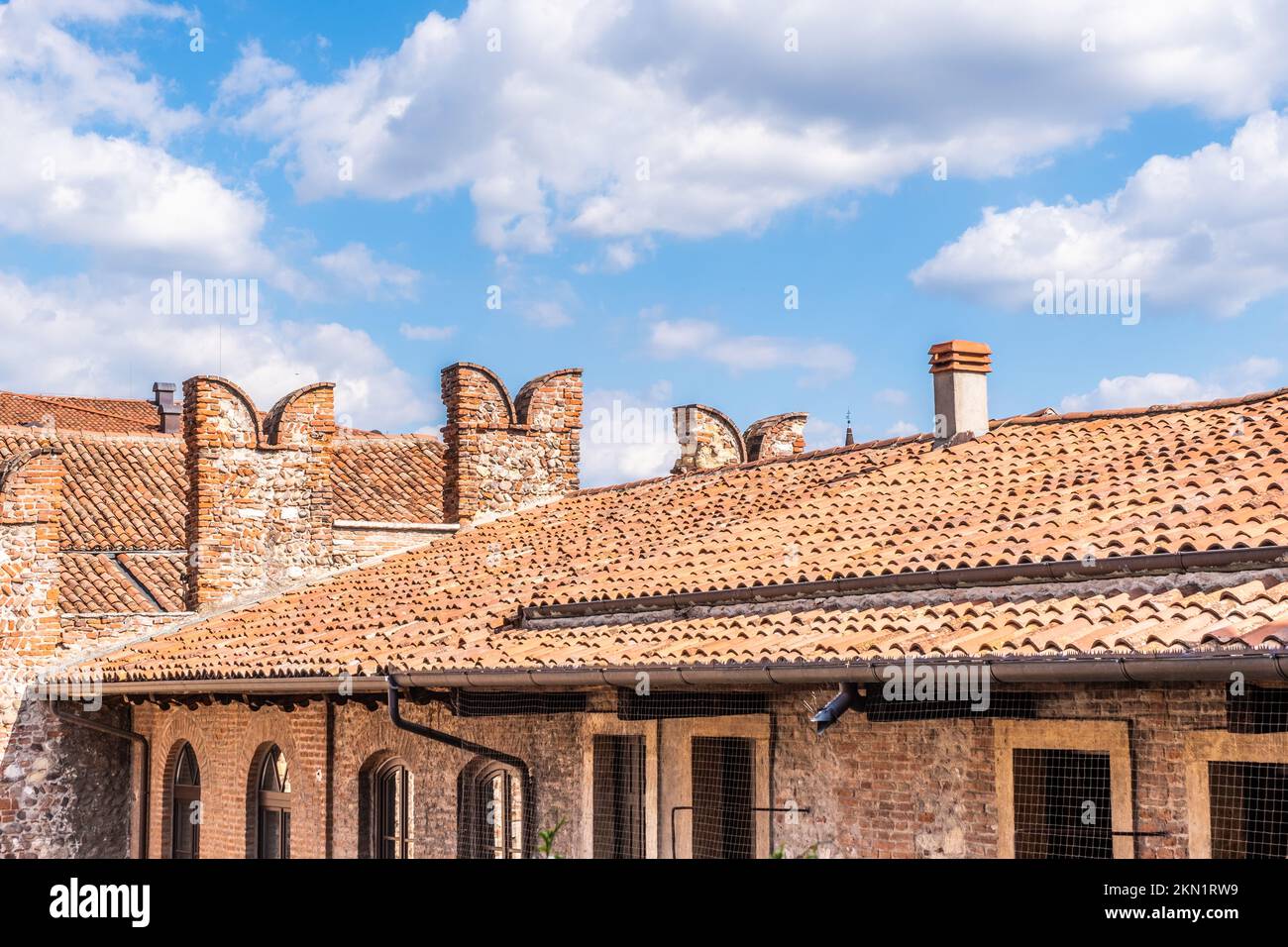 Medieval rooftop of houses with blue sky with clouds Stock Photo - Alamy