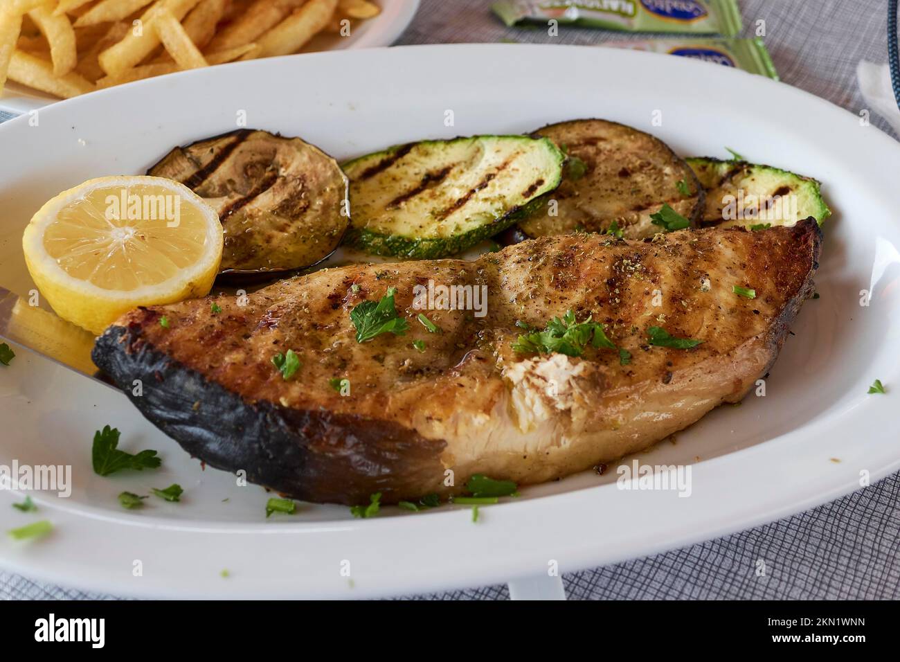 White plate, fried courgette, fried aubergine, grilled swordfish ...
