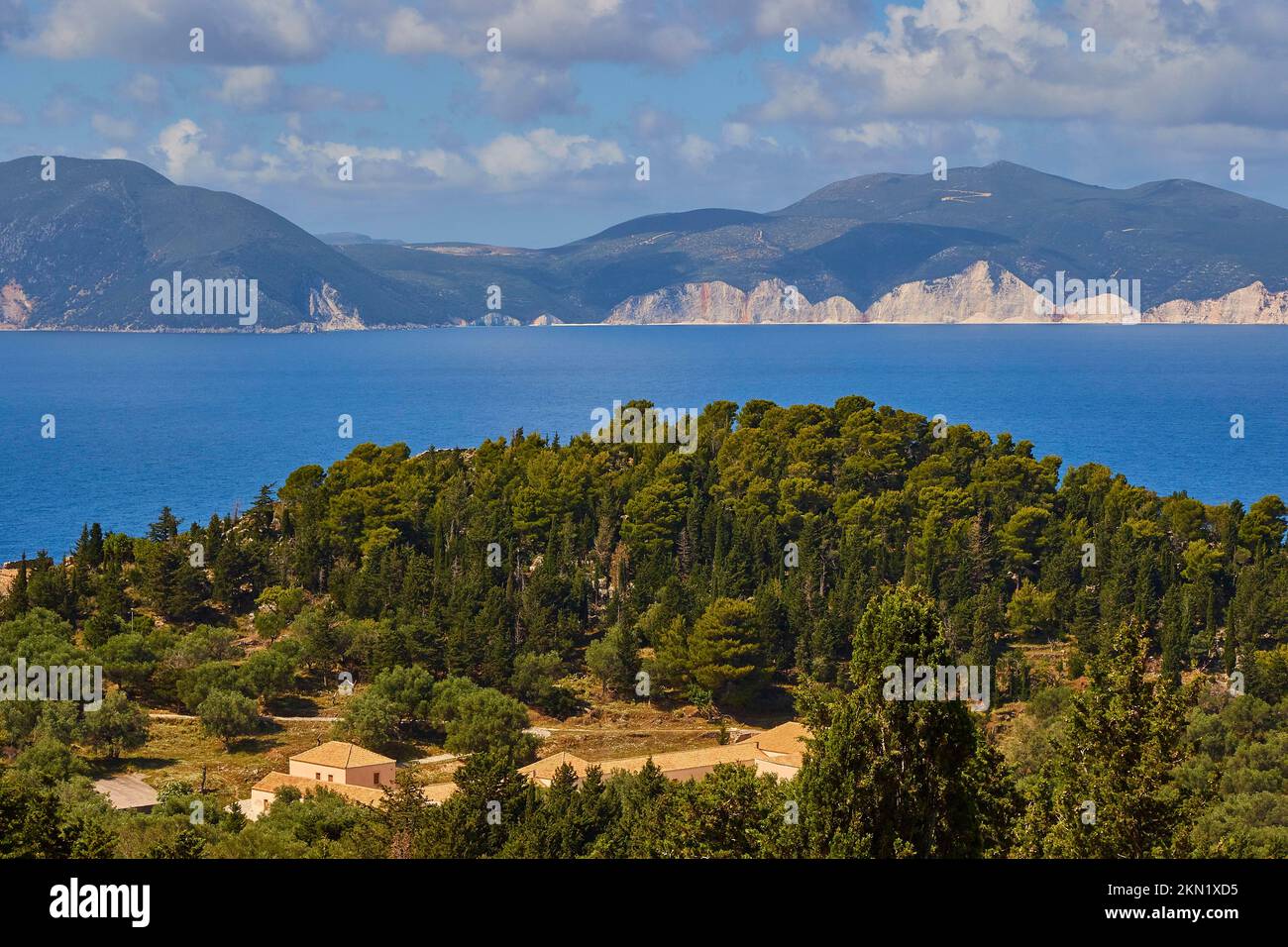Fortress, Assos, blue sky with white clouds, rugged cliff, trees ...