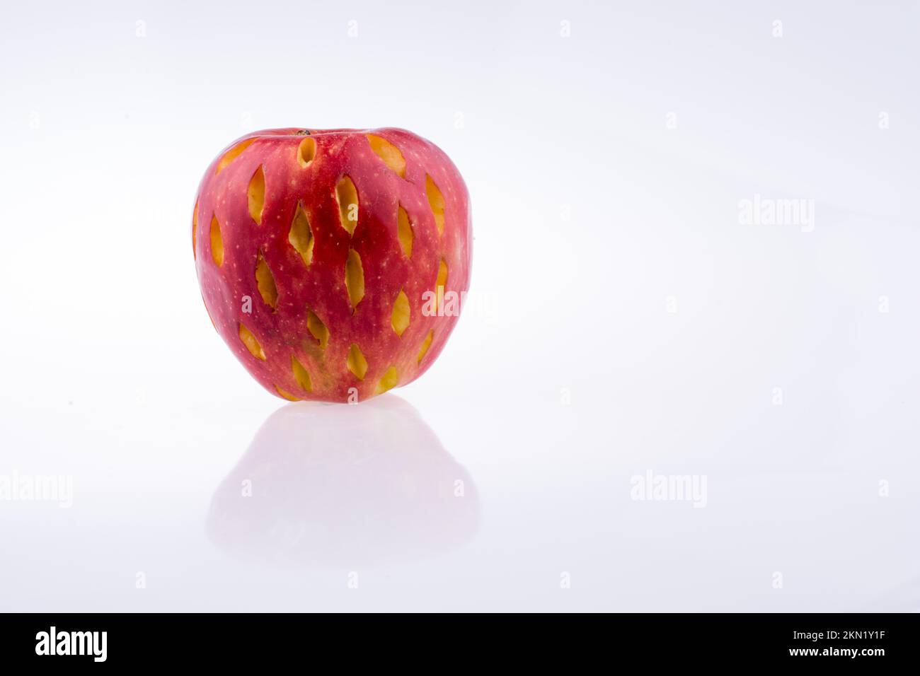 Rotten red apple on a white background Stock Photo - Alamy