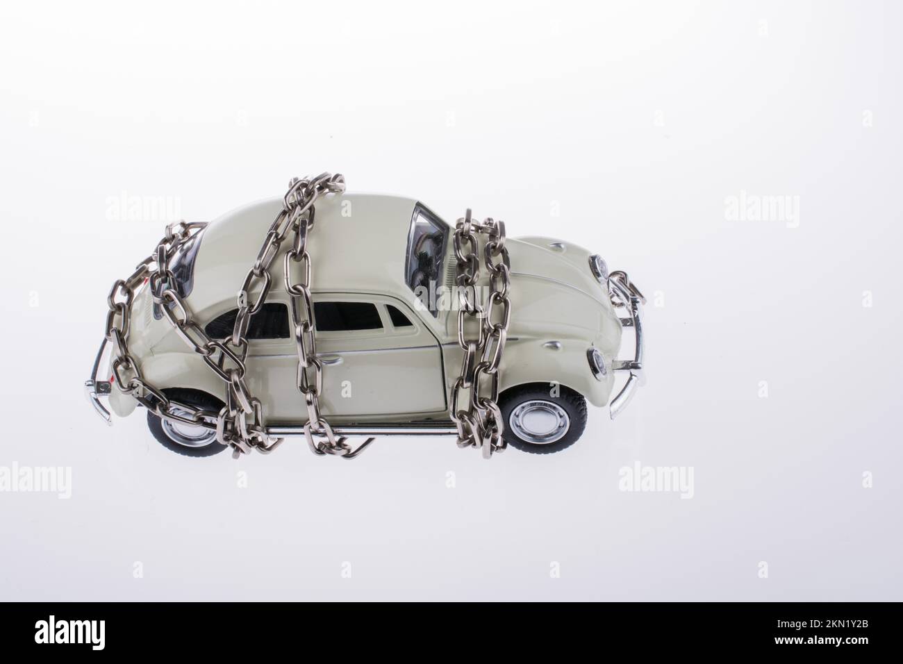 Chained white car on white background Stock Photo - Alamy