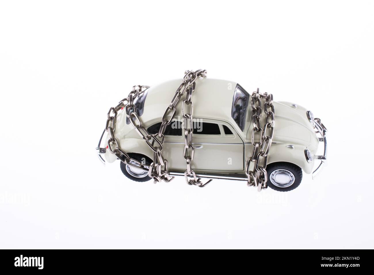 Chained white car on white background Stock Photo - Alamy
